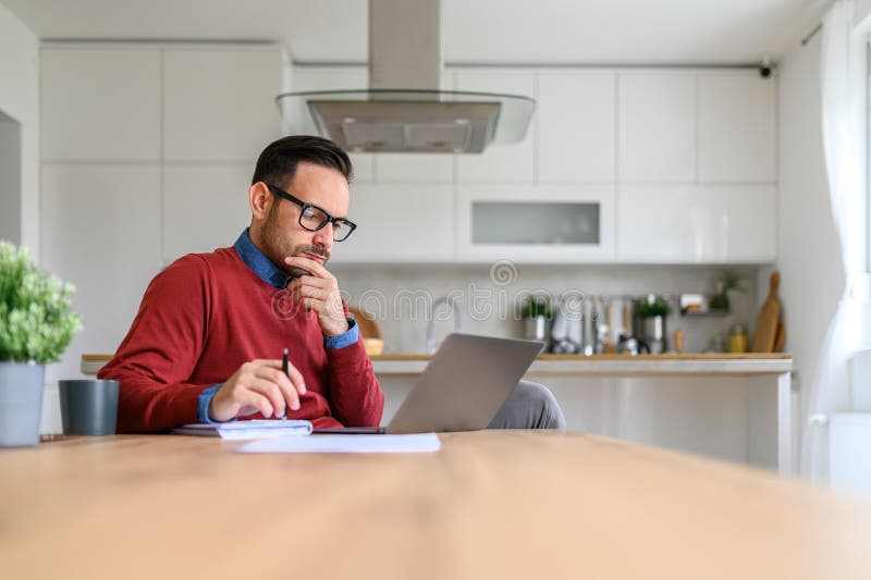 Businessman with Hand on Chin Thinking Ideas and Writing on Notepad ...