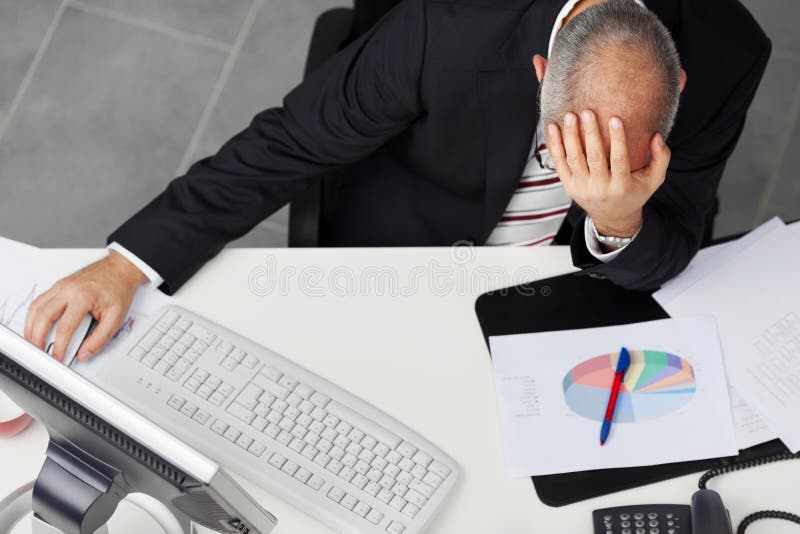 Businessman with Hand on Head at Desk Stock Photo - Image of office ...