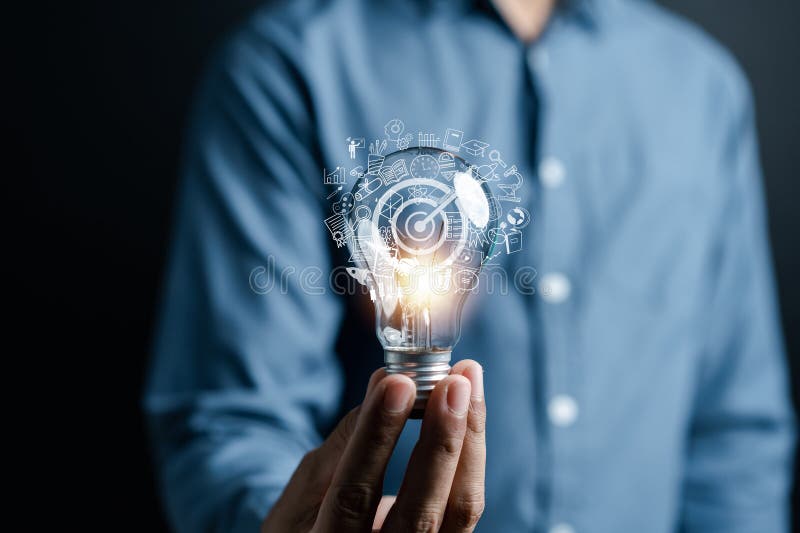 Businessman Hand Holding Lightbulb with Target Objective Inside, New ...