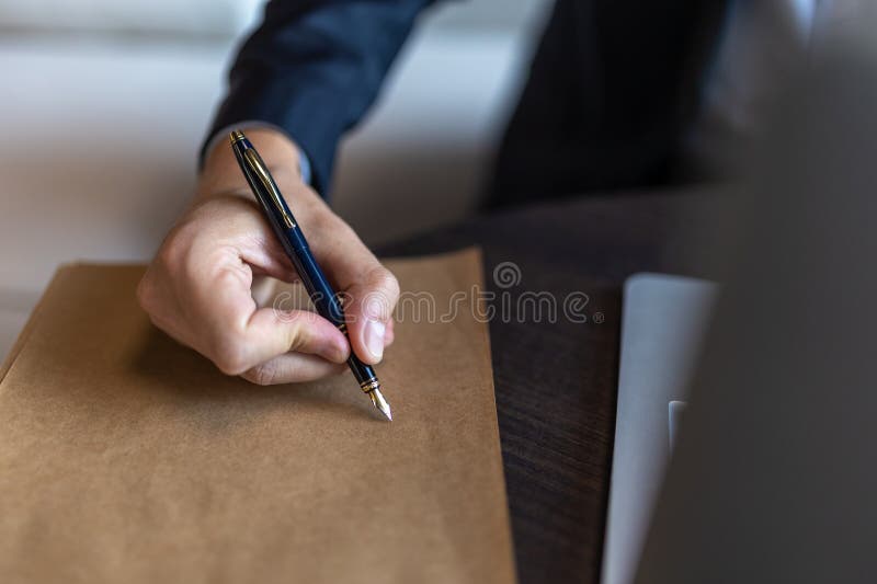 Businessman Hand with Pen Writing Notes on Paper while Working on ...