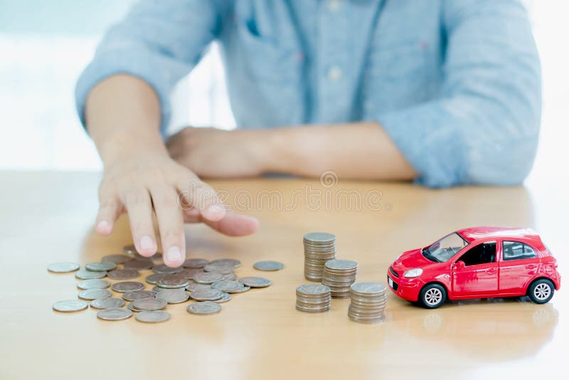 Businessman Hand Pushing a Toy Car Over a Stack of Coins Stock Image ...