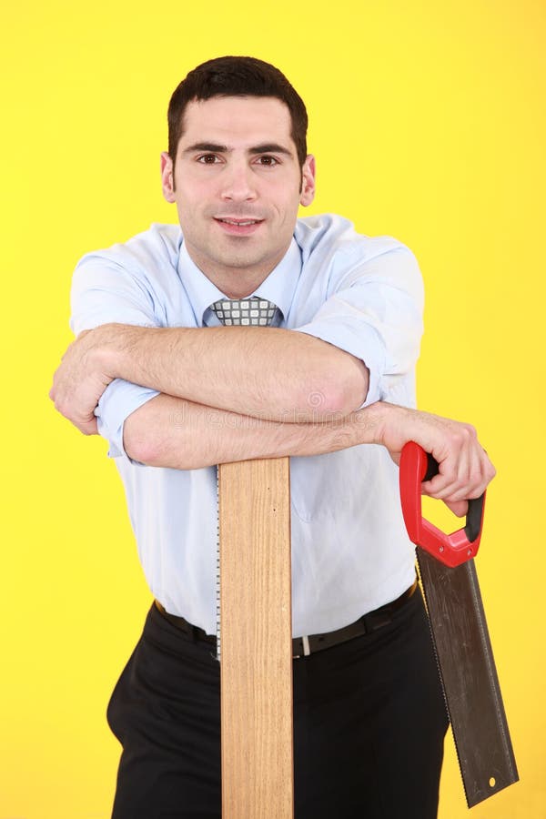 Businessman with hand-saw stock photo. Image of construction - 26585326