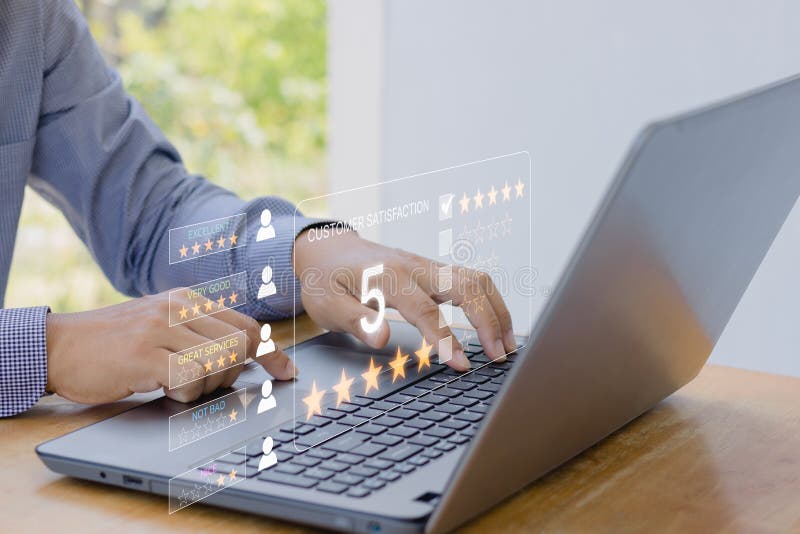 Businessman Hand Using Computer Notebook with Pop Up Five Star Icon for ...