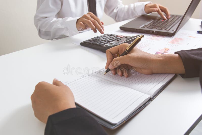 Businessman Hand Writing on Notebook with Finances Paning about Cost ...