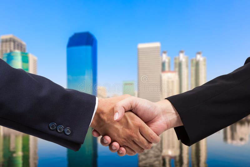 Businessman Handshake with Building Background Stock Photo - Image of ...