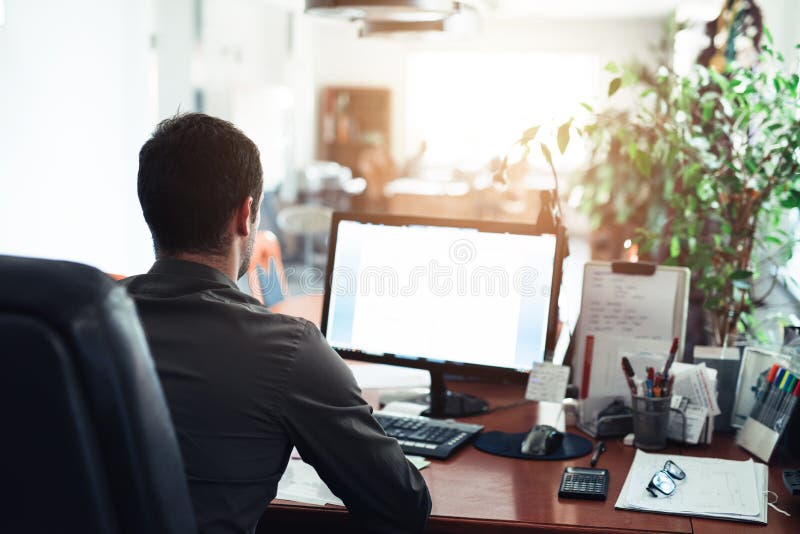 Businessman Hard at Work on a Computer in an Office Stock Image - Image ...