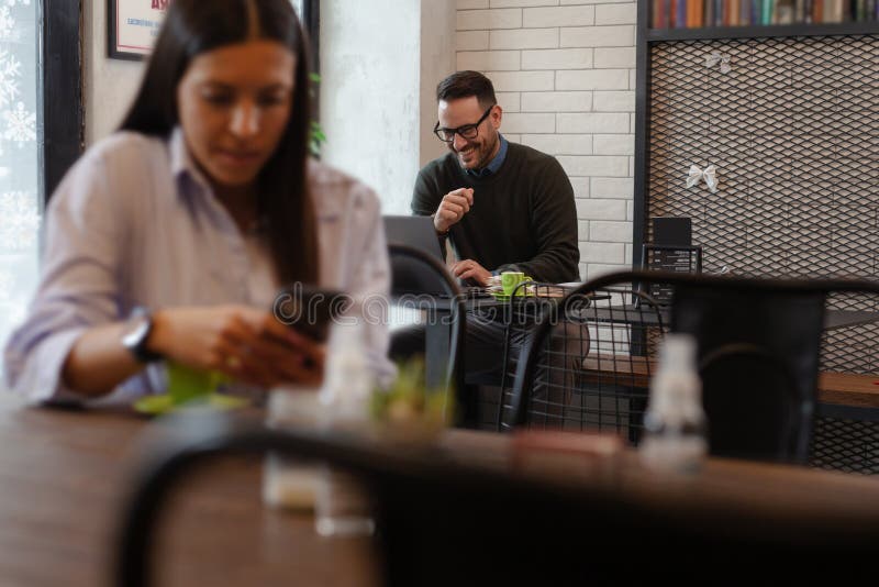 Businessman Having Coffee and Doing His Work in Cafe. Back Focus Stock ...