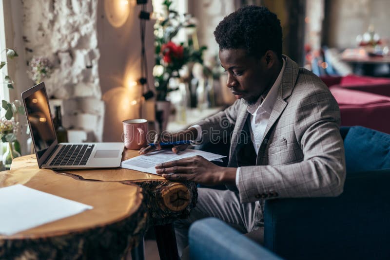 Businessman Having Coffee and Doing His Work in Cafe. Stock Image ...