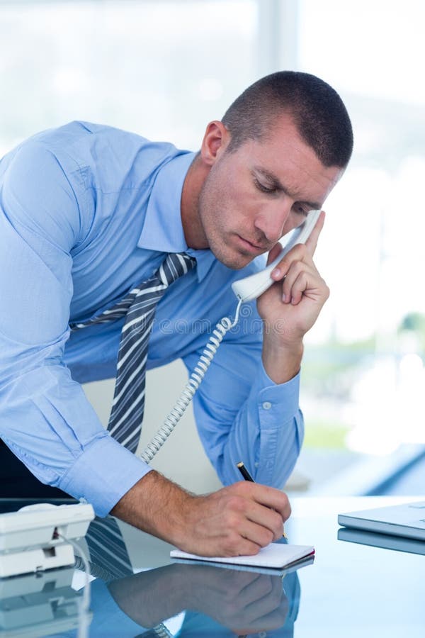 Businessman Having a Phone Call and Writing Notes Stock Photo - Image ...