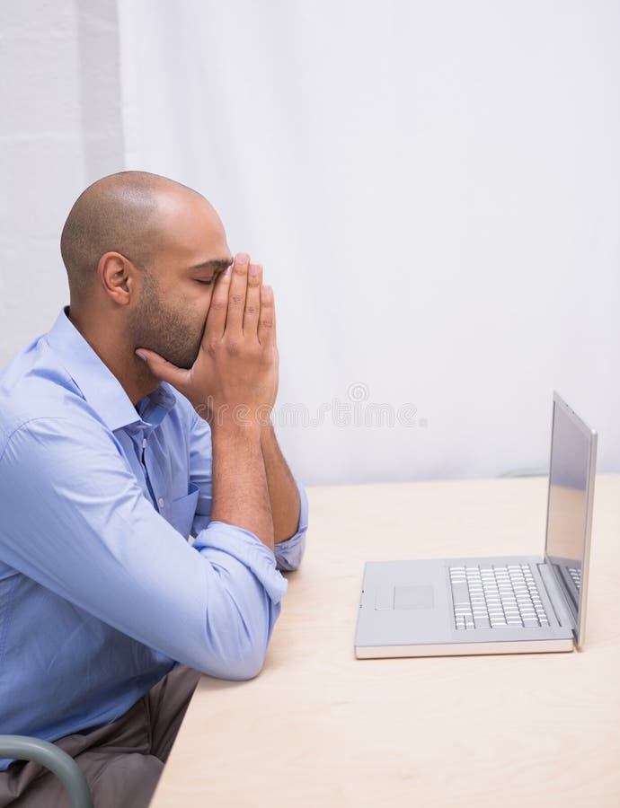 Businessman with Head in Hands by Laptop at Desk Stock Image - Image of ...