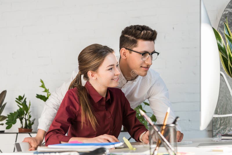 Businessman Helping His Colleague with Computer Work and Embracin Her ...