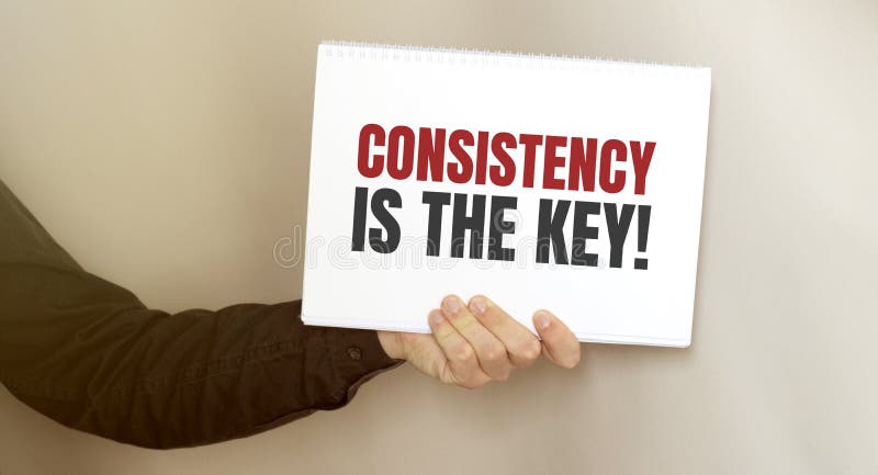 Businessman Holding a Card with Text Consistency is the Key Stock Photo ...