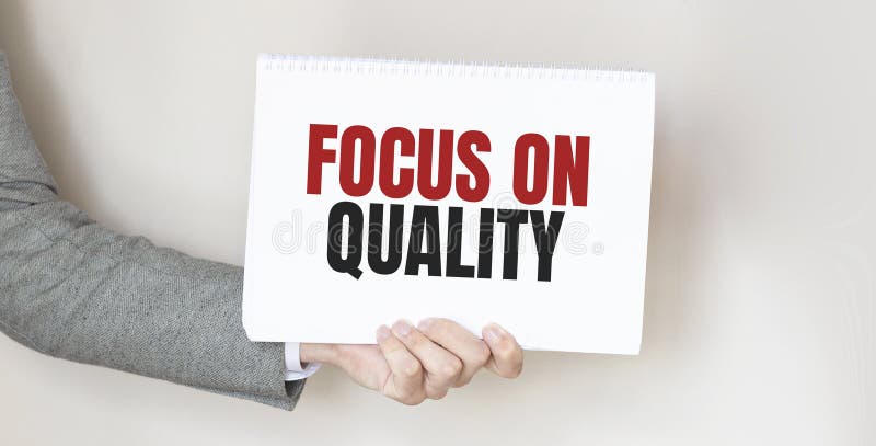 Businessman Holding a Card with Text FOCUS on QUALITY Stock Image ...