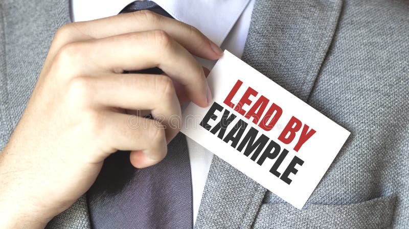 Businessman Holding a Card with Text Lead by Example Stock Image ...