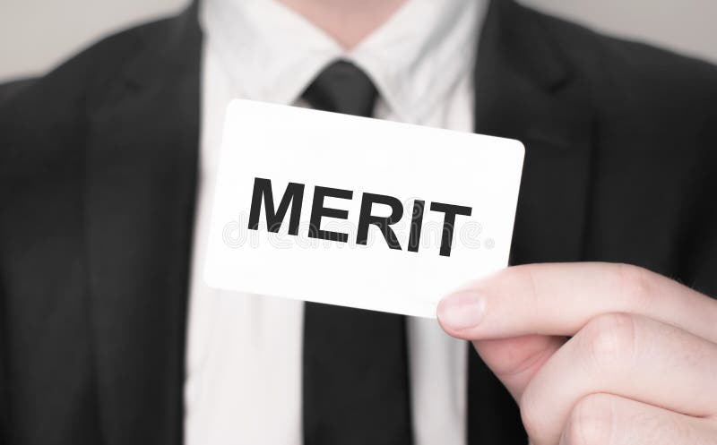 Businessman Holding a Card with Text Merit Stock Photo - Image of card ...