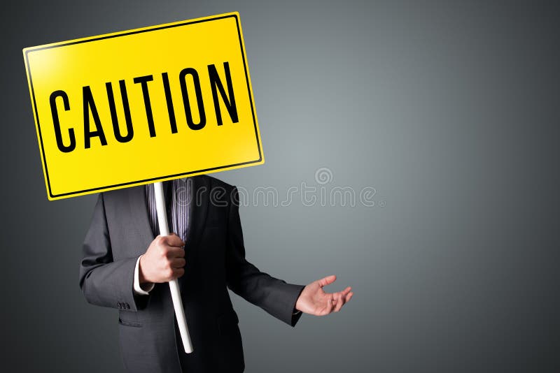 Businessman Holding A Caution Sign Stock Photo - Image of beware ...