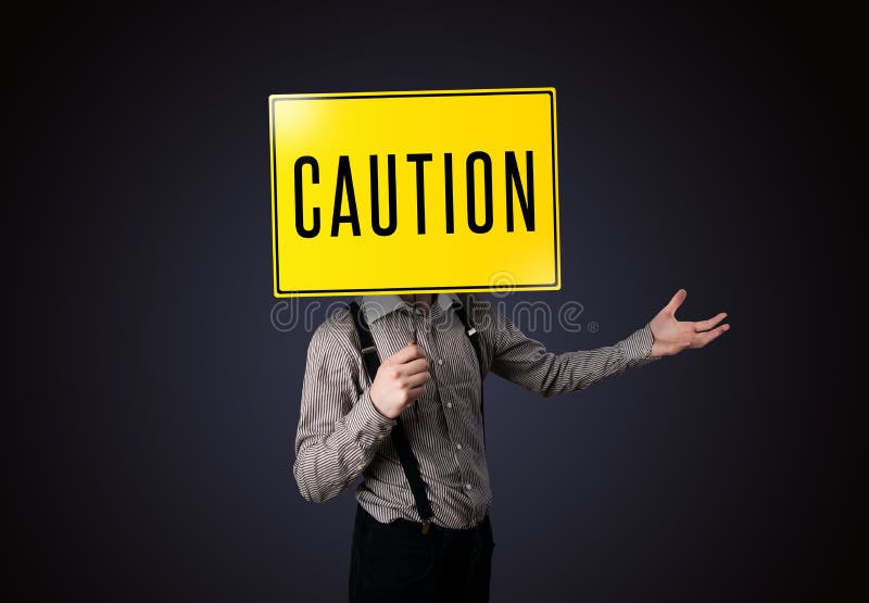 Businessman Holding a Caution Sign Stock Photo - Image of hold, casual ...