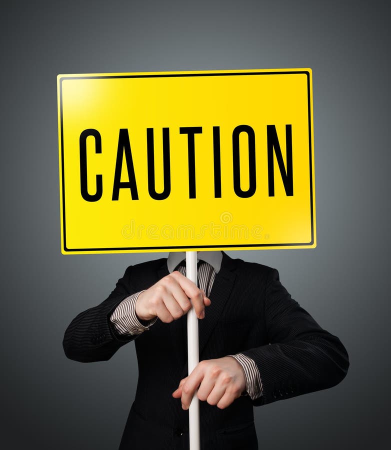 Businessman Holding a Caution Sign Stock Image - Image of holding ...