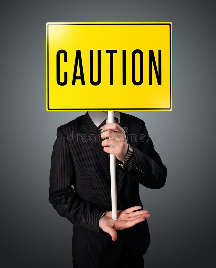 Businessman Holding a Caution Sign Stock Photo - Image of hide, hazard ...
