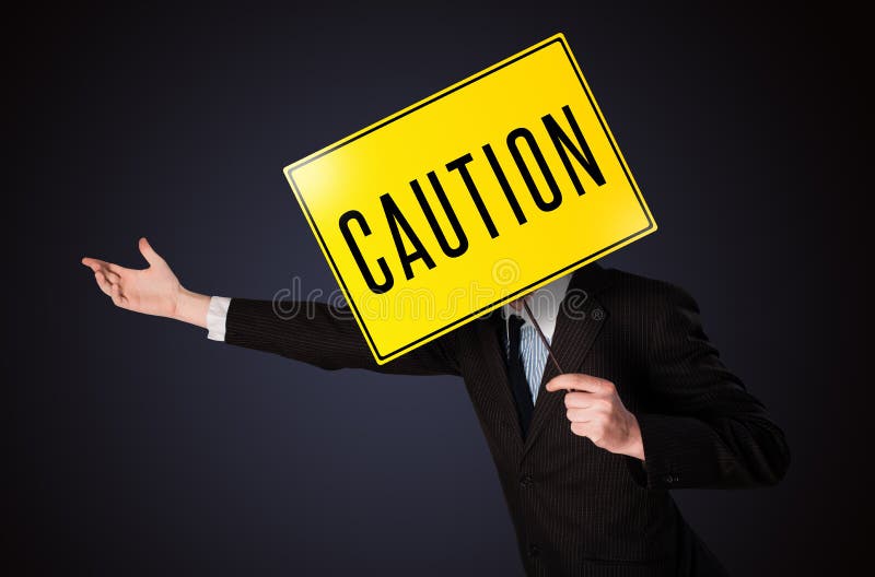 Businessman Holding a Caution Sign Stock Image - Image of hold, formal ...
