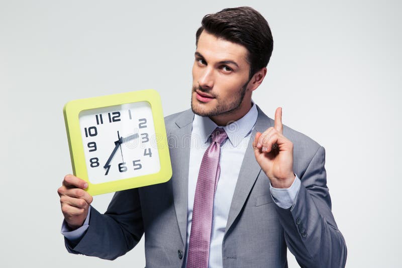 Businessman holding clock stock photo. Image of attire - 55130150