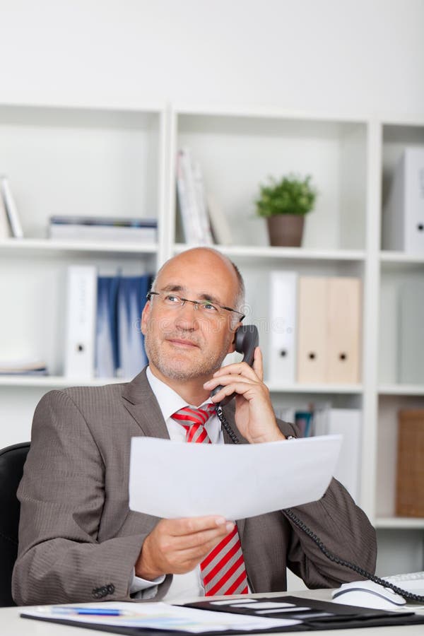 Businessman Holding Document while Using Landline Phone Stock Image ...