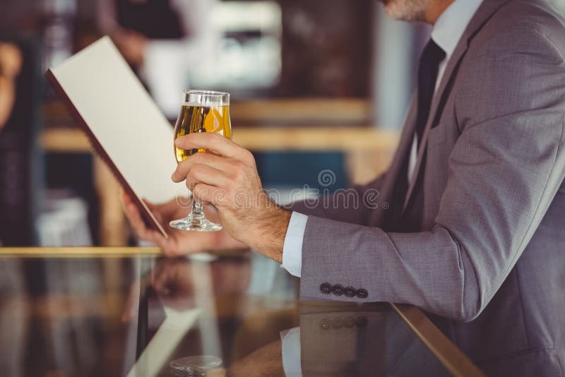 Man Looking at Menu in Restaurant Stock Image - Image of female ...