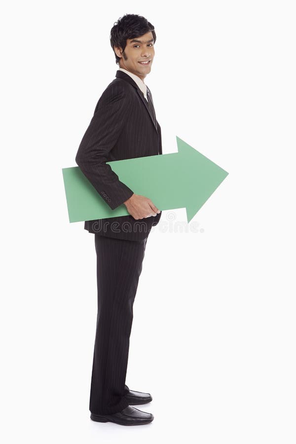 Businessman Holding a Green Arrow, Facing Left Stock Photo - Image of ...