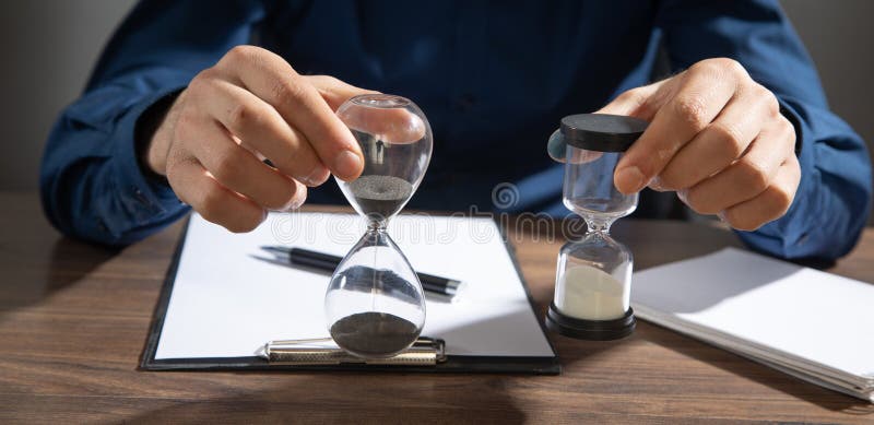 Businessman Holding Hourglass on the Table Stock Image - Image of ...