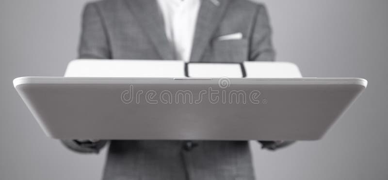 Businessman Holding Laptop Computer in Office Stock Image - Image of ...