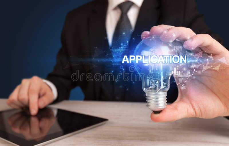 Businessman Holding a Light Bulb Stock Photo - Image of idea ...