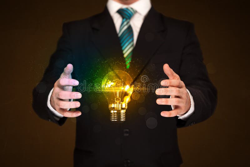 Businessman Holding Light Bulb Stock Image - Image of gesture, formal ...