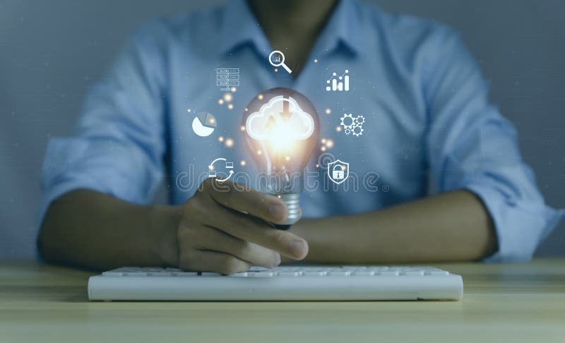 Businessman Holding a Light Bulb Showing a Diagram of Cloud Computing ...