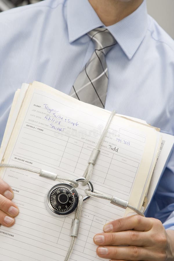 Businessman Holding Locked File Folders Stock Photo - Image of business ...