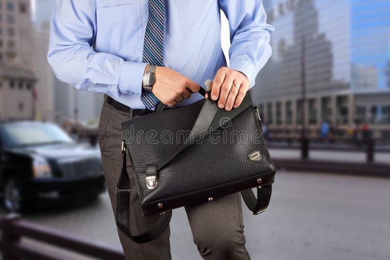 Businessman Holding and Opening a Leather Briefcase Stock Image - Image ...