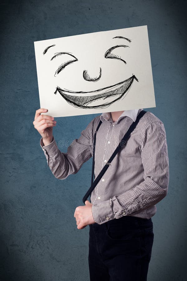 Businessman Holding a Paper with Smiley Face in Front of His Head Stock ...