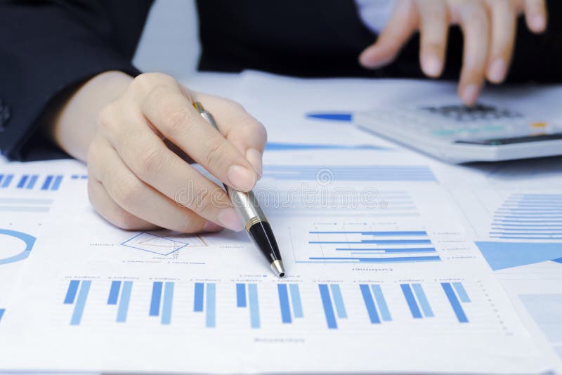 Businessman Holding a Profitability Statistics Analysis Pen from a ...