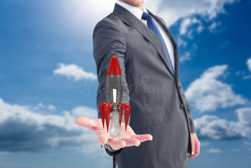 Businessman Holding a Rocket in His Hands with Blue Sky Background ...