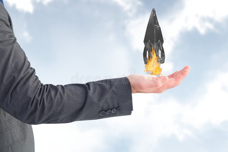 Businessman Holding a Rocket Taking Off from His Hand Against Sky ...