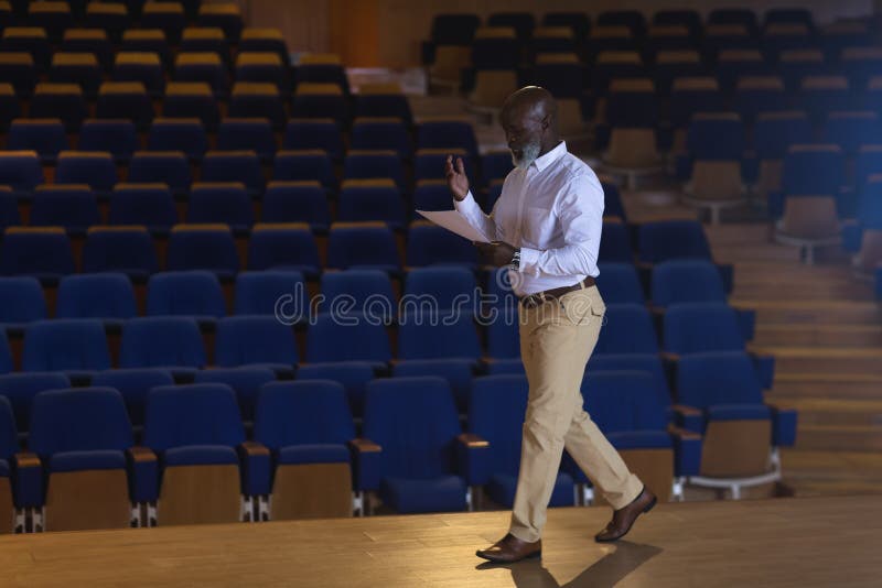 Businessman with Holding Script Walking in a Auditorium Stock Image ...