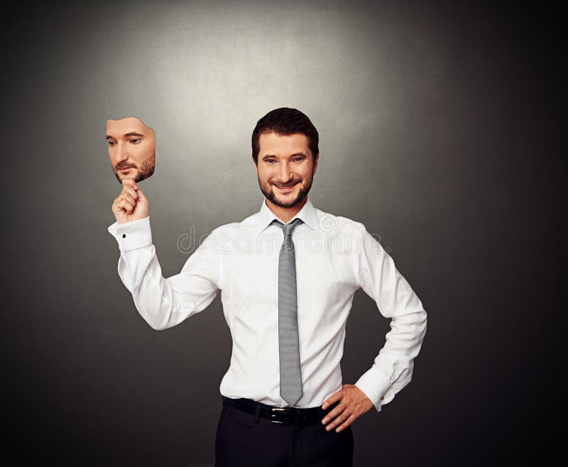 Man Holding Mask with Smiley Face Stock Photo - Image of mood, holding ...