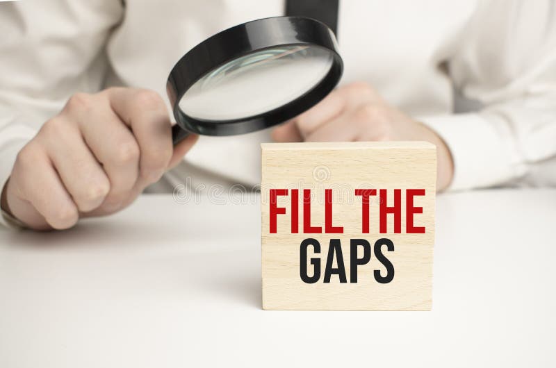 Businessman Holding Sheet of Paper with a Message FILL the GAPS Stock ...