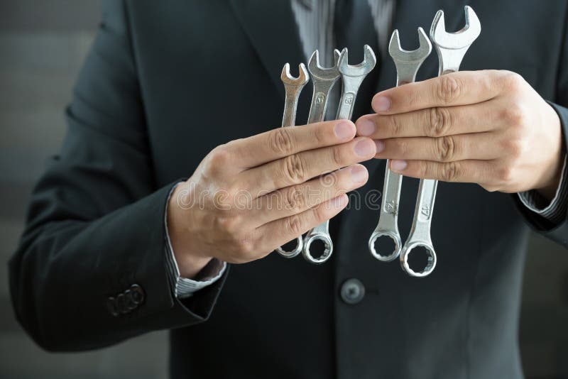 Businessman Holding Spanner in Hand Stock Photo - Image of male ...