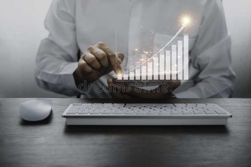 Businessman Holding Tablet with Keyboard of Computer Analyzing Sales ...