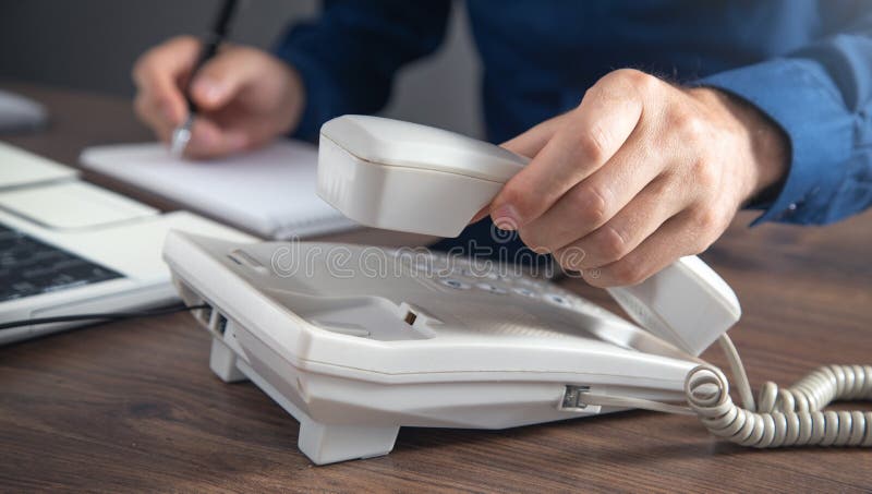 Businessman Holding Telephone Receiver at the Office Table Stock Photo ...