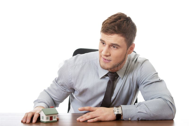 Businessman with House Model by a Desk. Stock Image - Image of ...