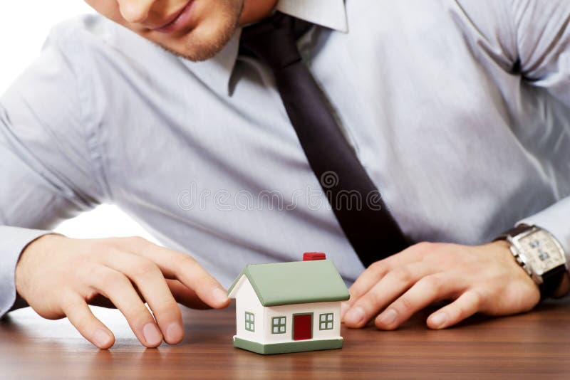 Businessman with House Model by a Desk. Stock Image - Image of holding ...
