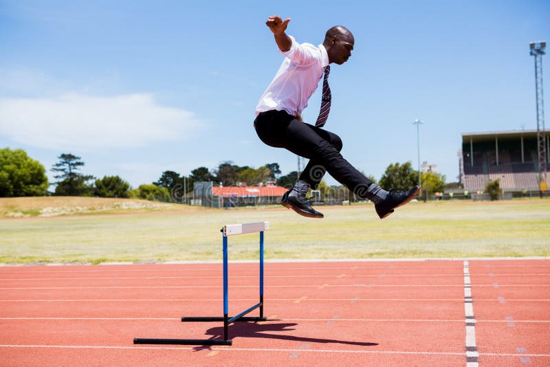 Businessman Jumping a Hurdle while Running Stock Image - Image of black ...