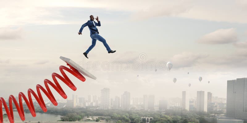 Businessman Jumping on Springboard . Mixed Media Stock Photo - Image of ...