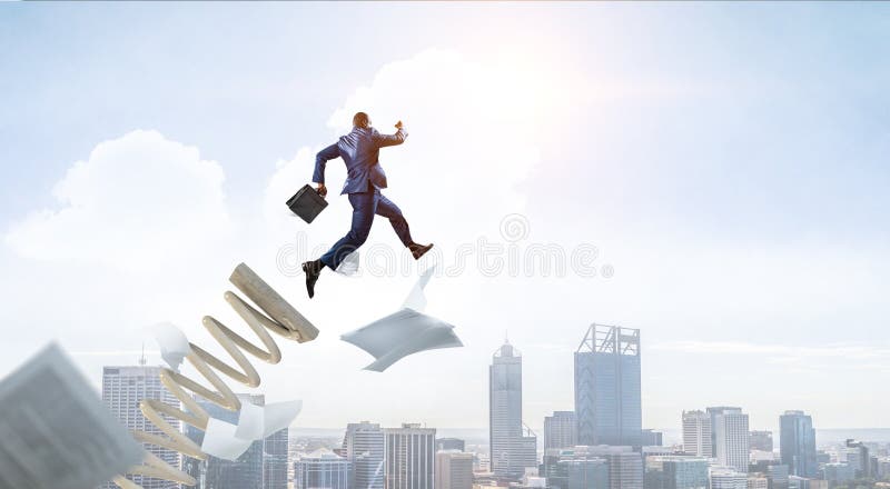 Businessman Jumping on Springboard . Mixed Media Stock Photo - Image of ...